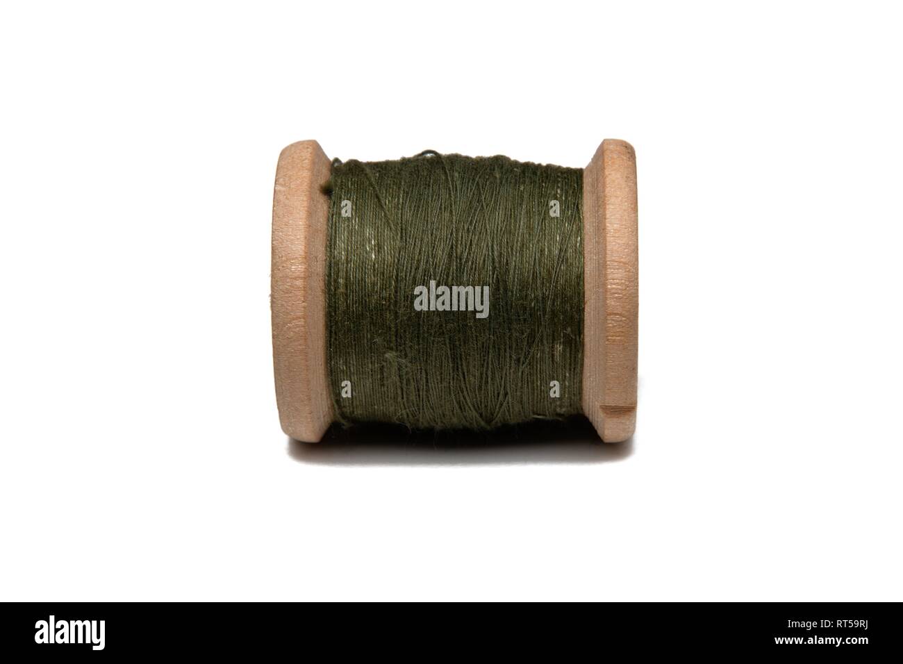 Wooden coil with sewing thread on a white background Stock Photo - Alamy