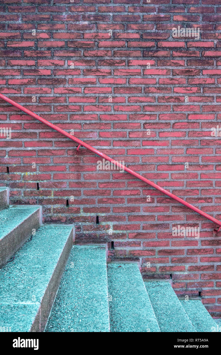 Exterior concrete stairs side view and the red brick wall and metal ...