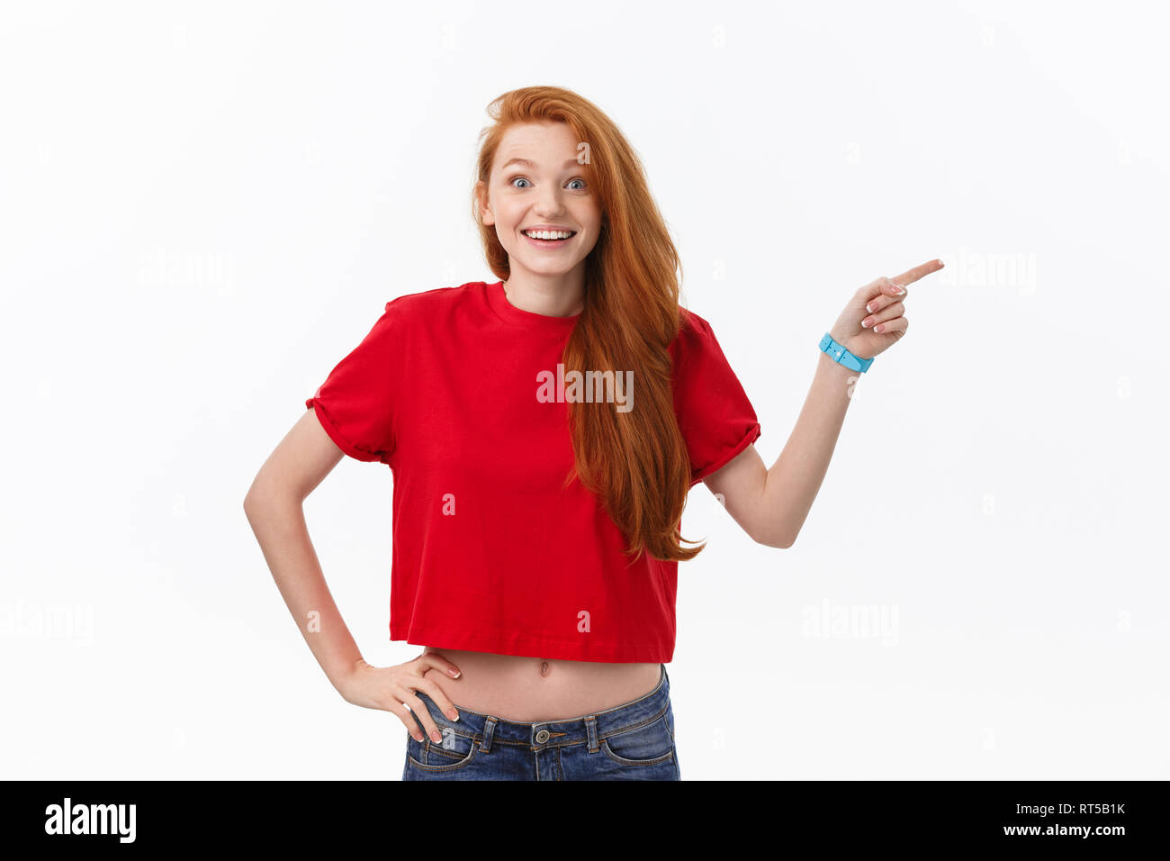 Photo of happy young woman standing isolated over white wall background ...