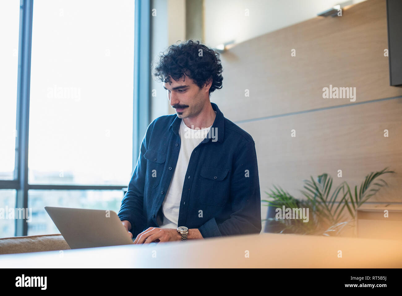 Man holding laptop typing hi-res stock photography and images - Alamy