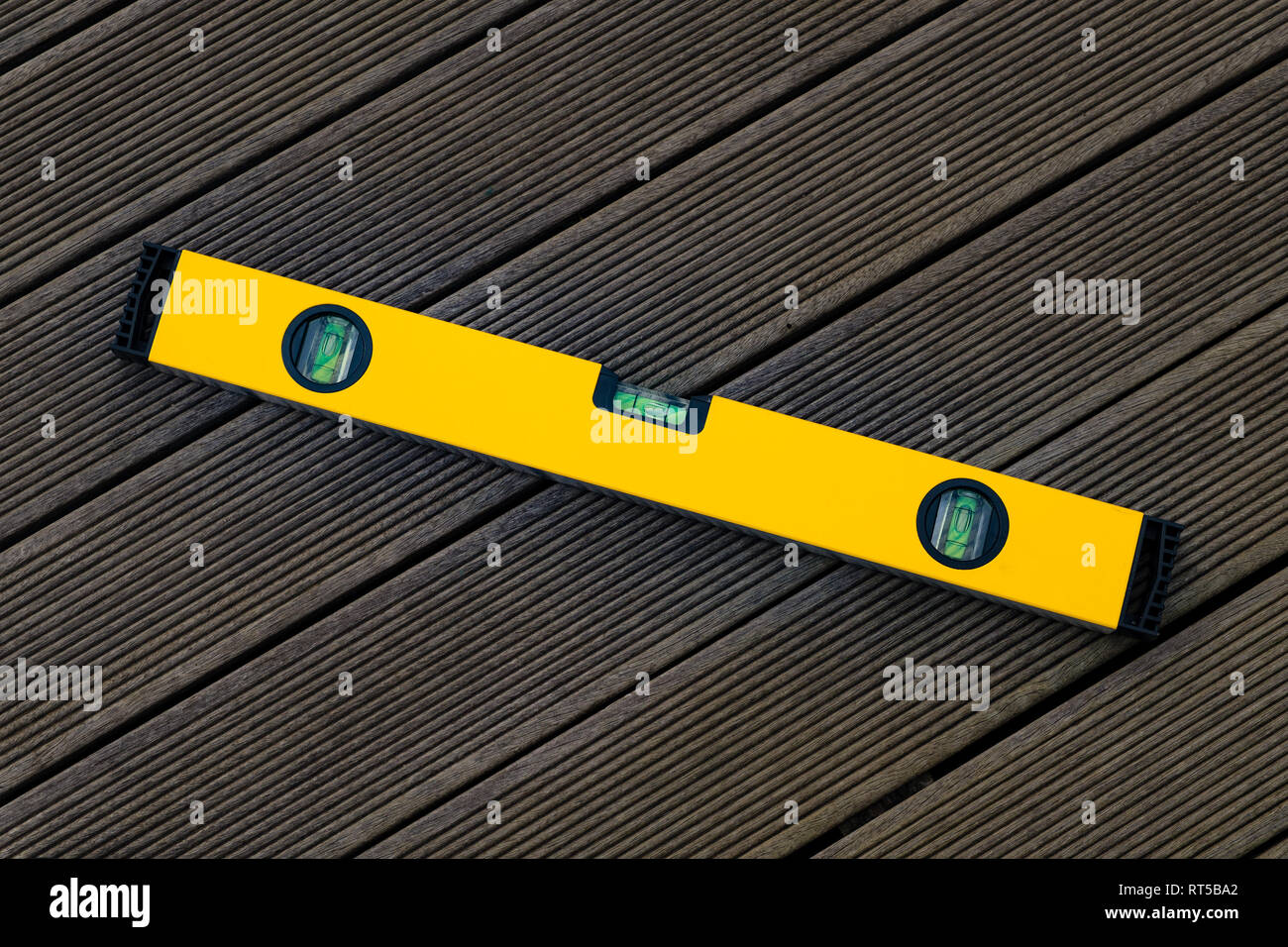 Yellow and Black Spirit Level on a wooden Decking Background Stock ...