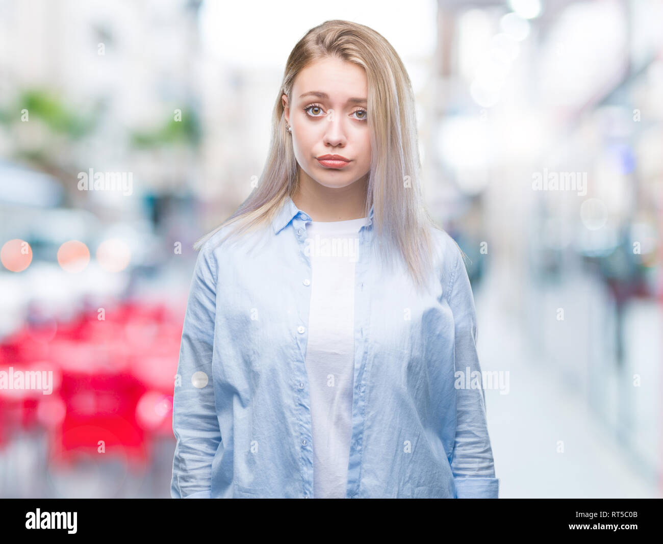 Young blonde woman over isolated background depressed and worry for ...