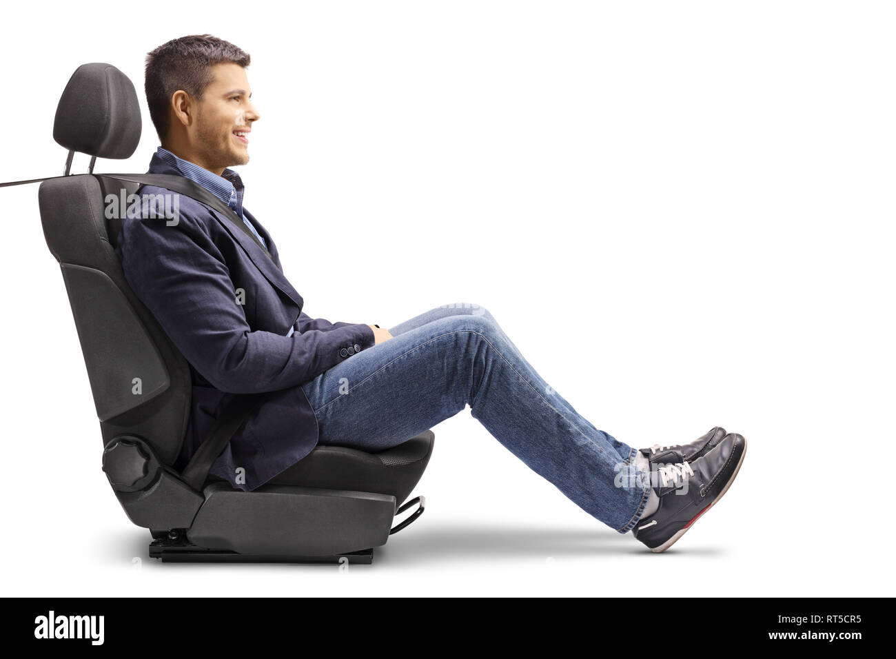 Full length profile shot of a young man in a car seat with a fastened ...