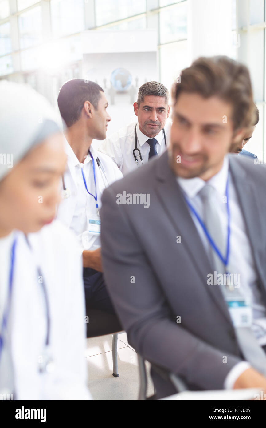 Male doctors interacting with each other during seminar Stock Photo - Alamy