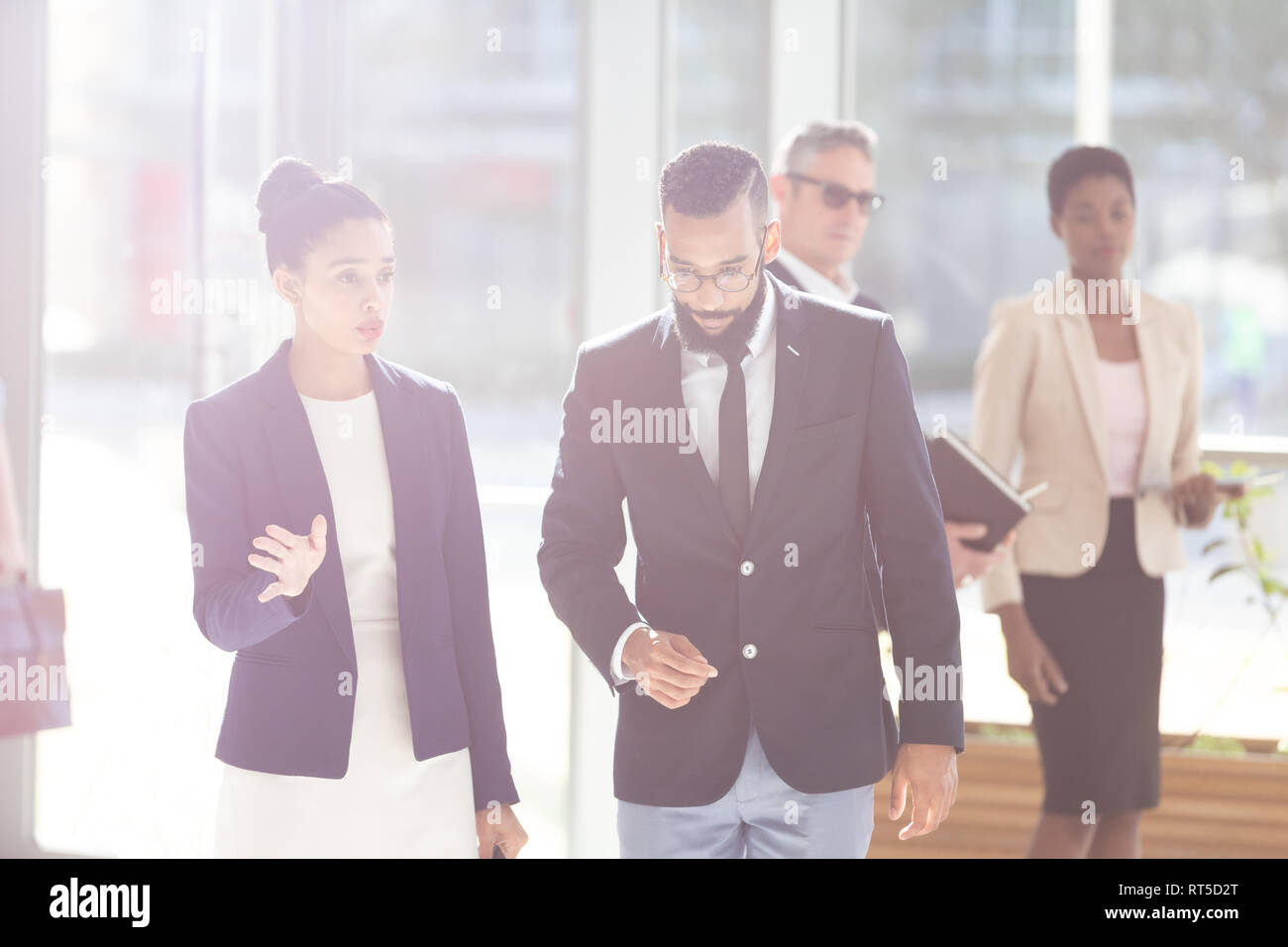 Business people interacting with each others in office lobby Stock ...