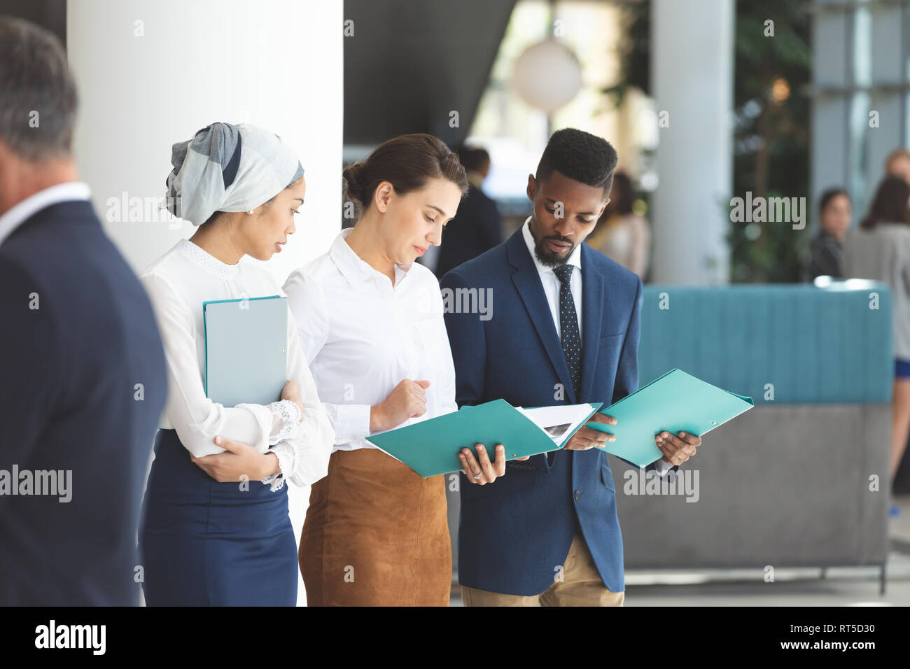 Diverse business people looking and discussing about files Stock Photo ...