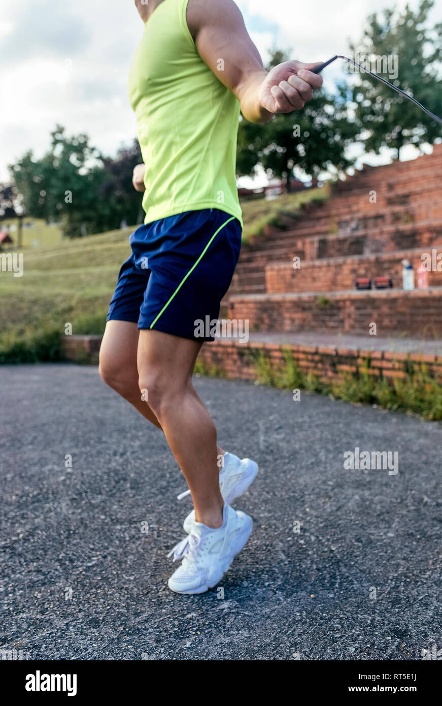 Close-up of muscular man skipping rope outdoors Stock Photo - Alamy