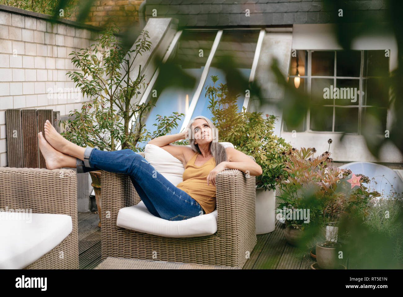 Woman relaxing on terrace Stock Photo - Alamy