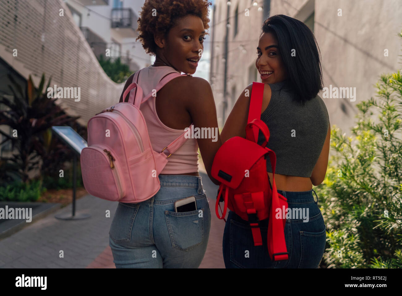 USA, Florida, Miami Beach, rear view of two happy female friends ...