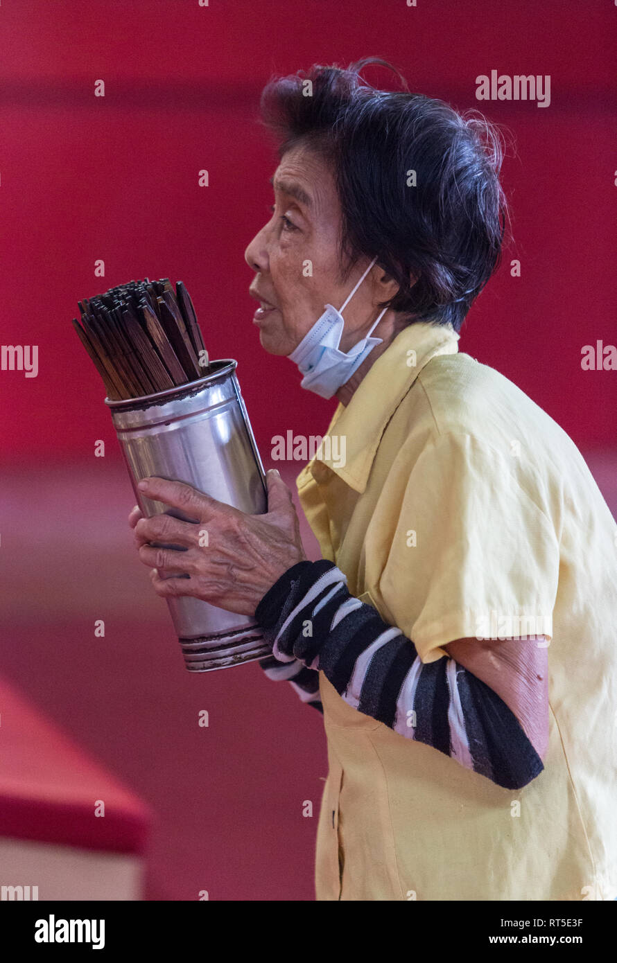 George Town, Penang, Malaysia. Worshiper with Chinese Fortune Sticks in ...