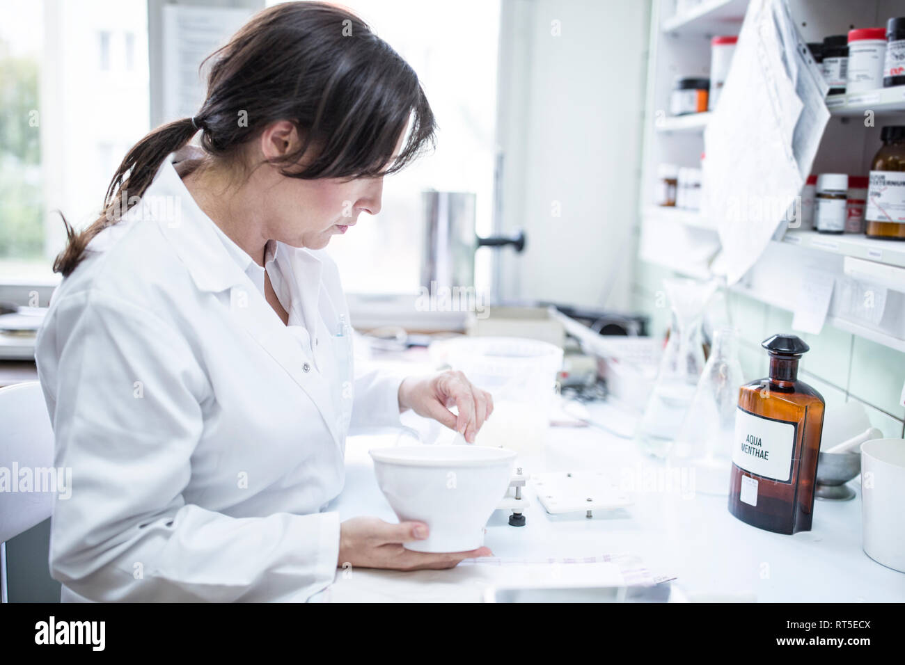 Woman preparing medicine in laboratory of a pharmacy Stock Photo - Alamy