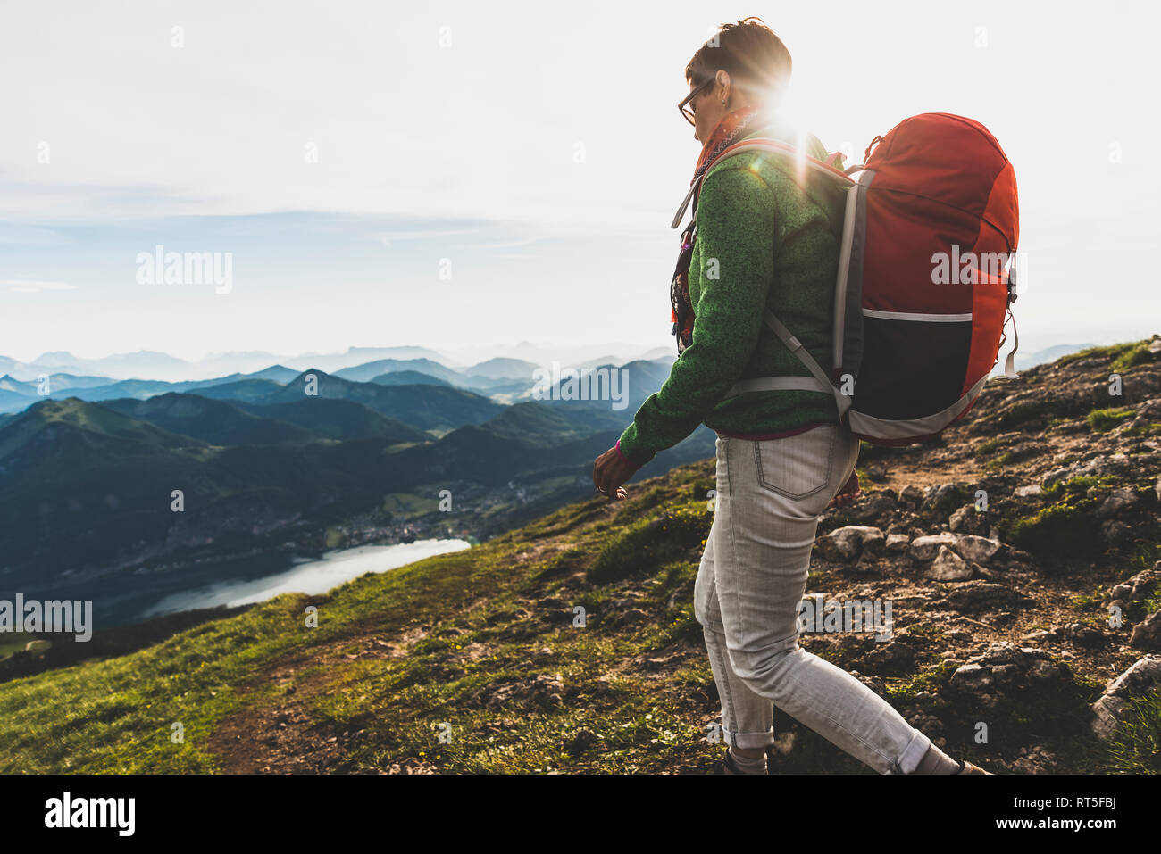 Austria, Salzkammergut, Hiker with backpack hiking in the Alps Stock ...