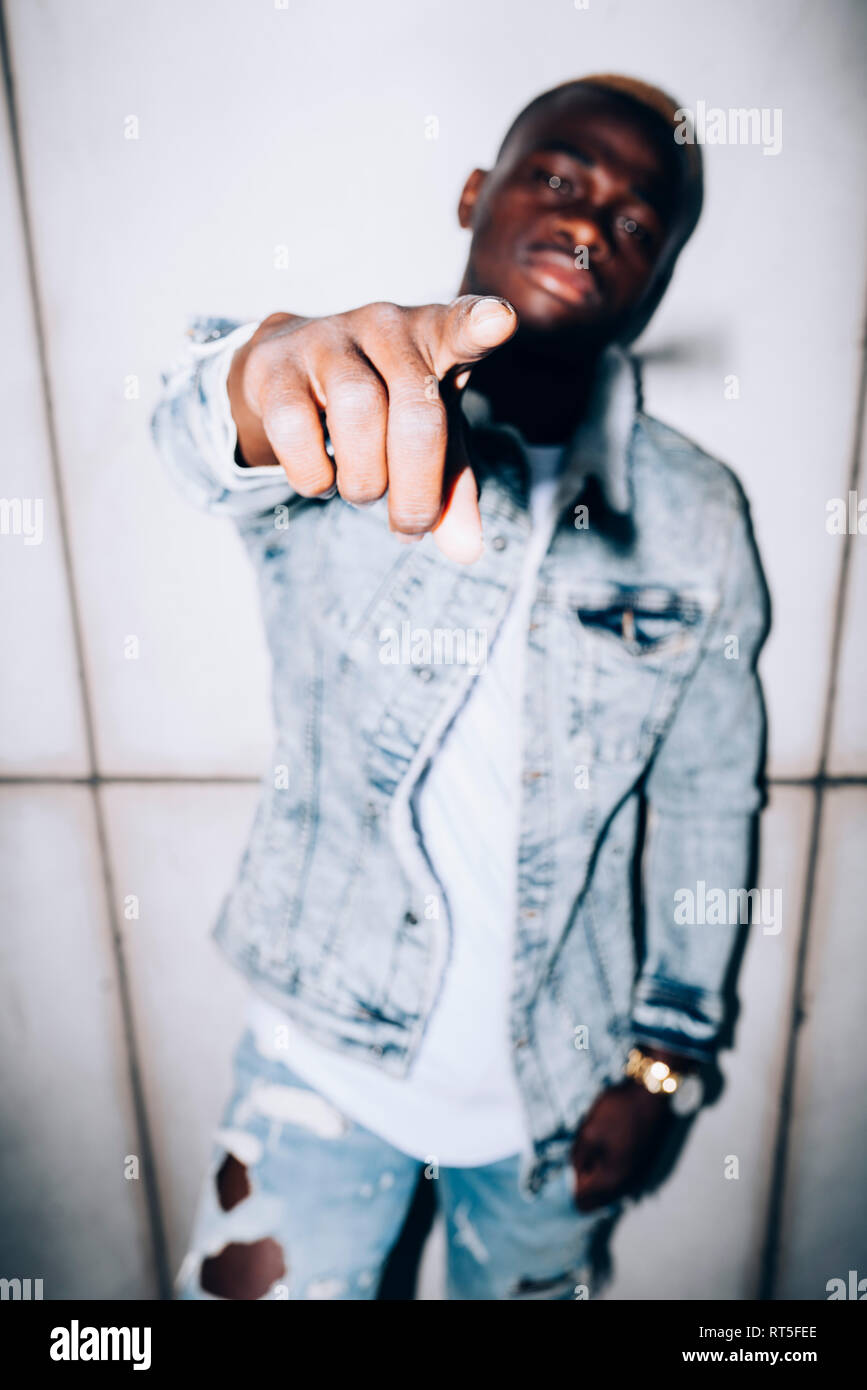 Young man raising finger hi-res stock photography and images - Alamy