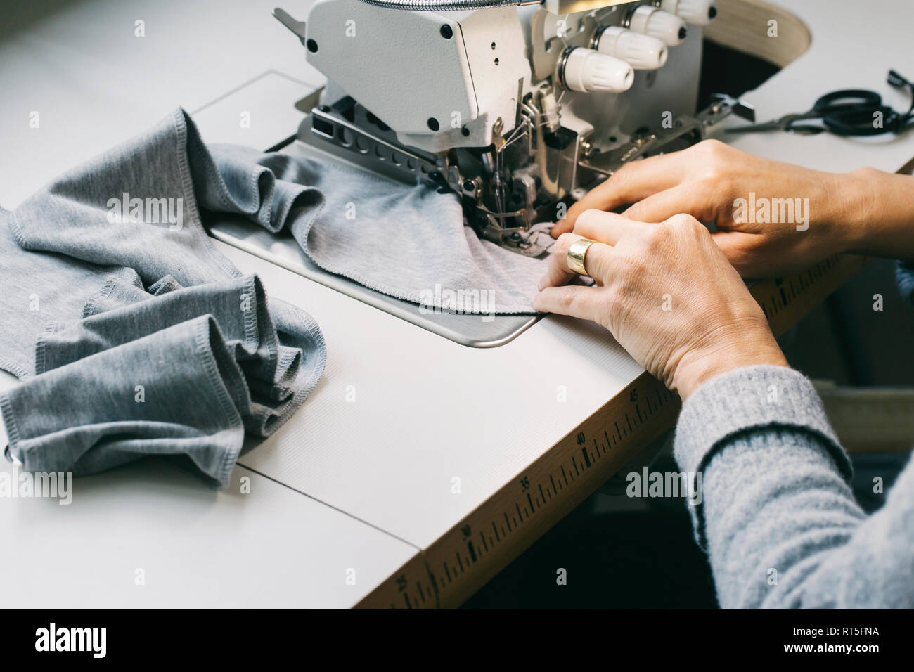 Close-up of woman using sewing machine Stock Photo - Alamy