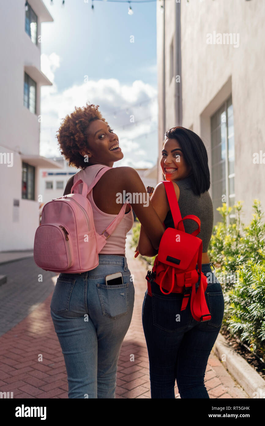 USA, Florida, Miami Beach, rear view of two happy female friends ...