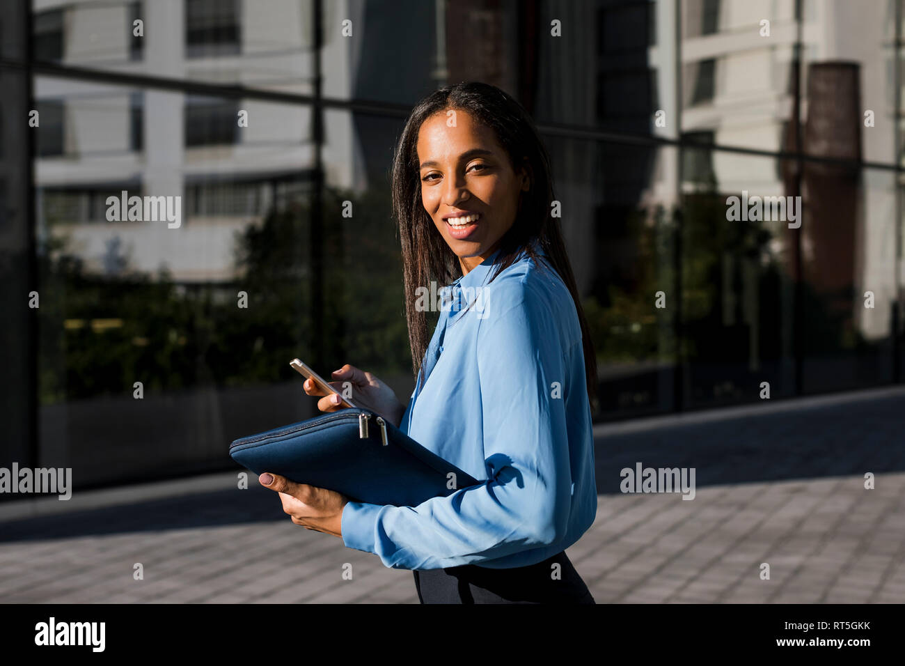 Businesswoman using smartphone, laptop bag Stock Photo - Alamy Businesswoman using smartphone, laptop bag Stock Photo - Alamy