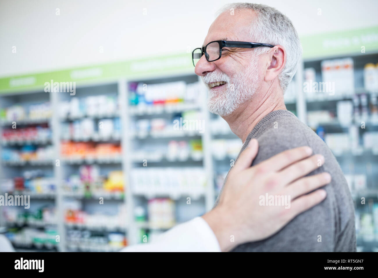 Smiling customer in pharmacy Stock Photo - Alamy