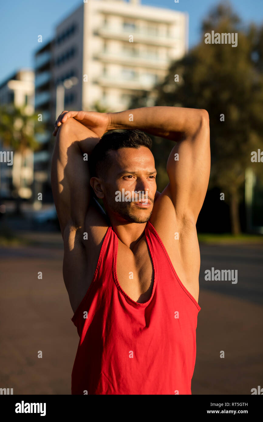 Male athlete practicing stretching exercises hi-res stock photography ...