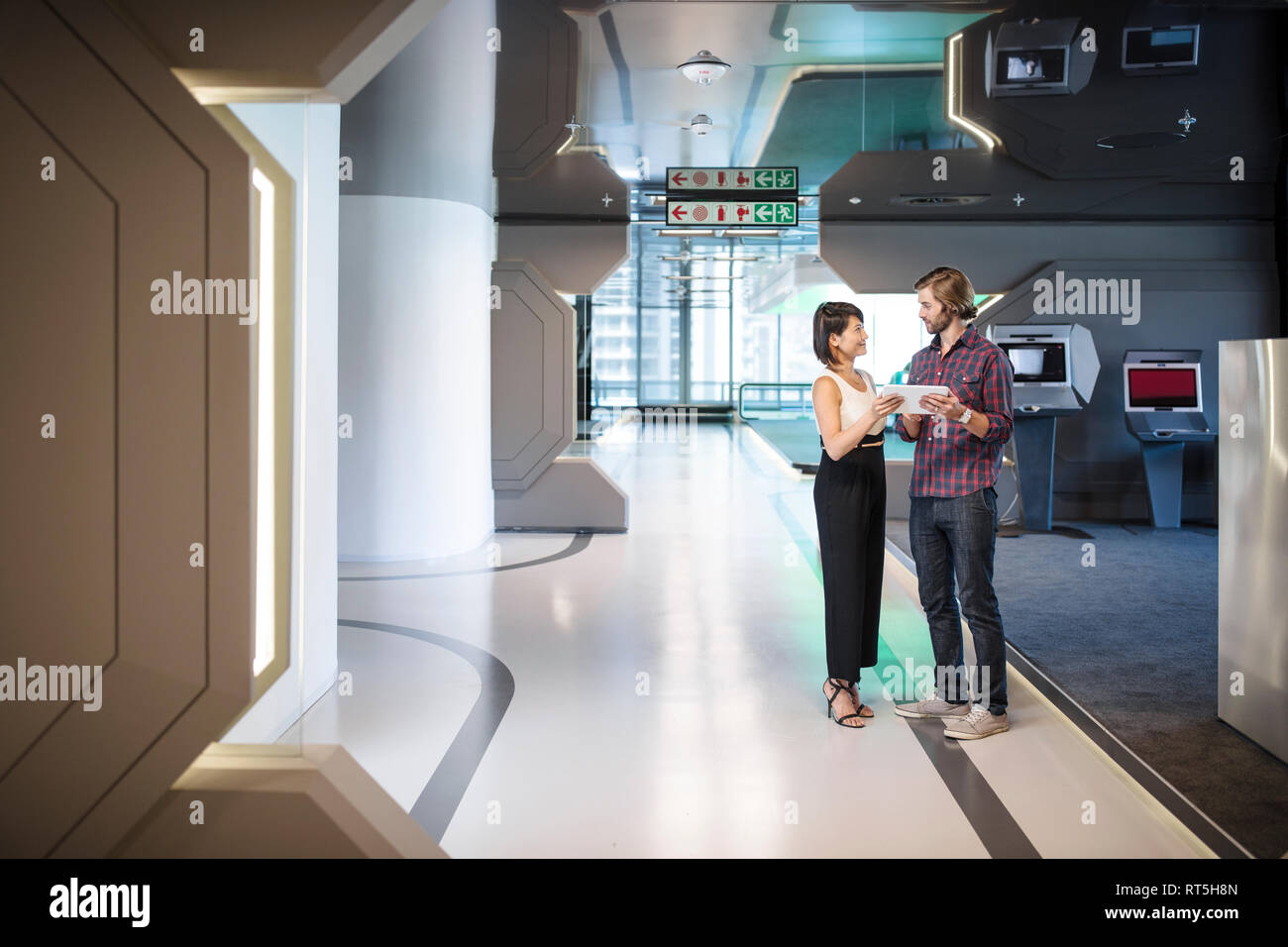 Business people discussing in an office corridor Stock Photo - Alamy