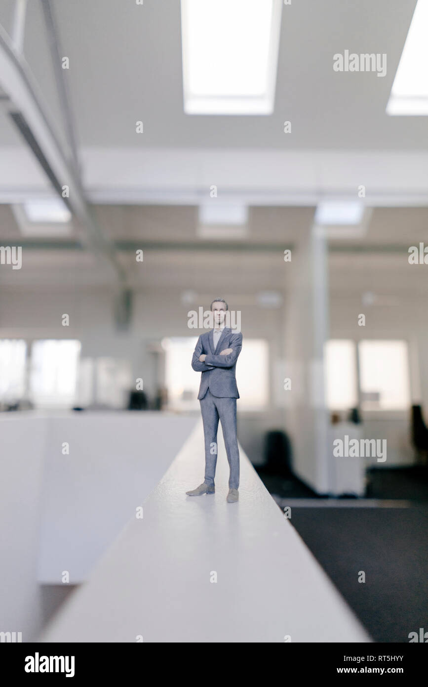Businessman figurine standing on desk in modern office Stock Photo - Alamy