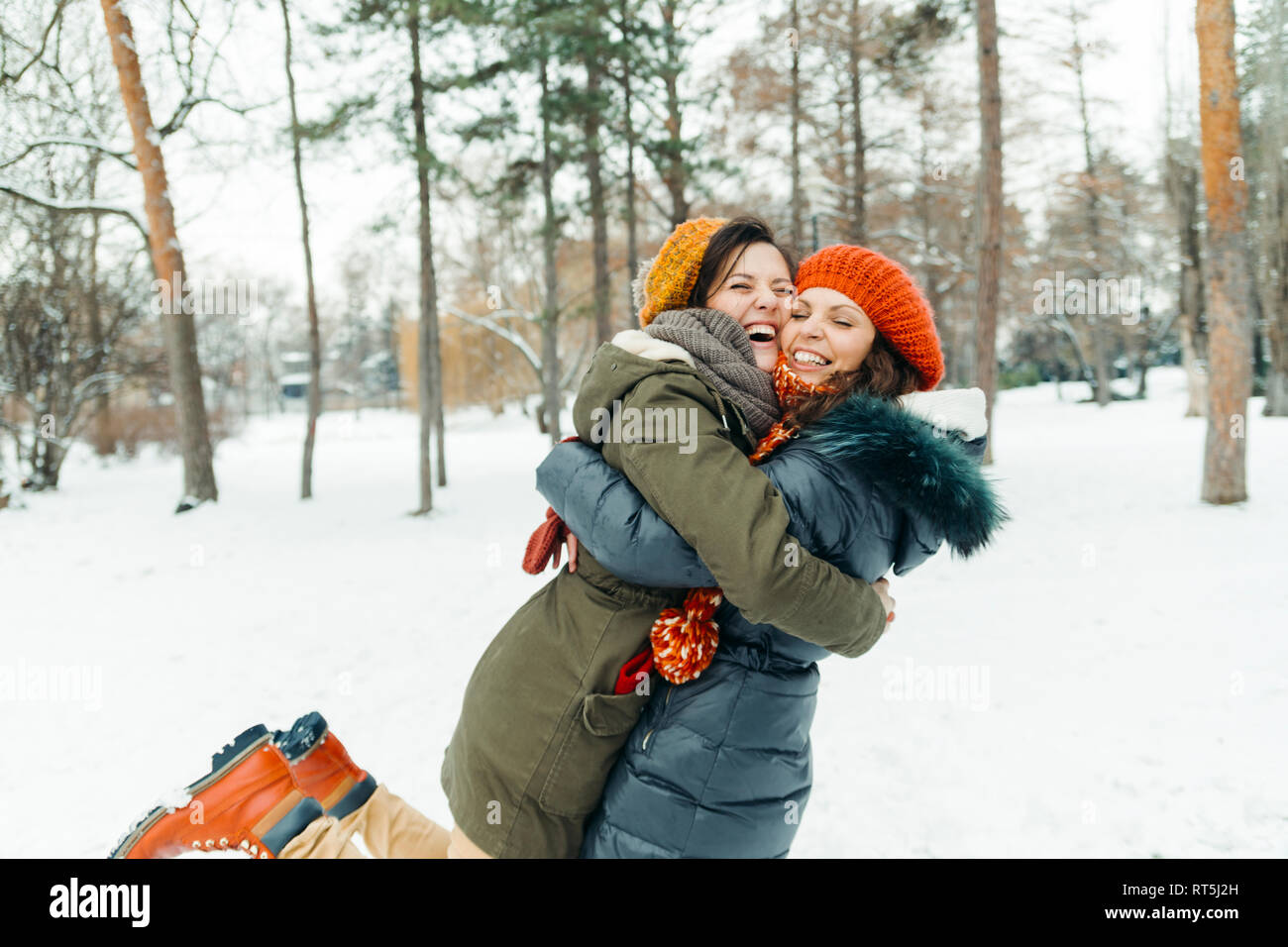 Two best friends having fun in the snow Stock Photo - Alamy