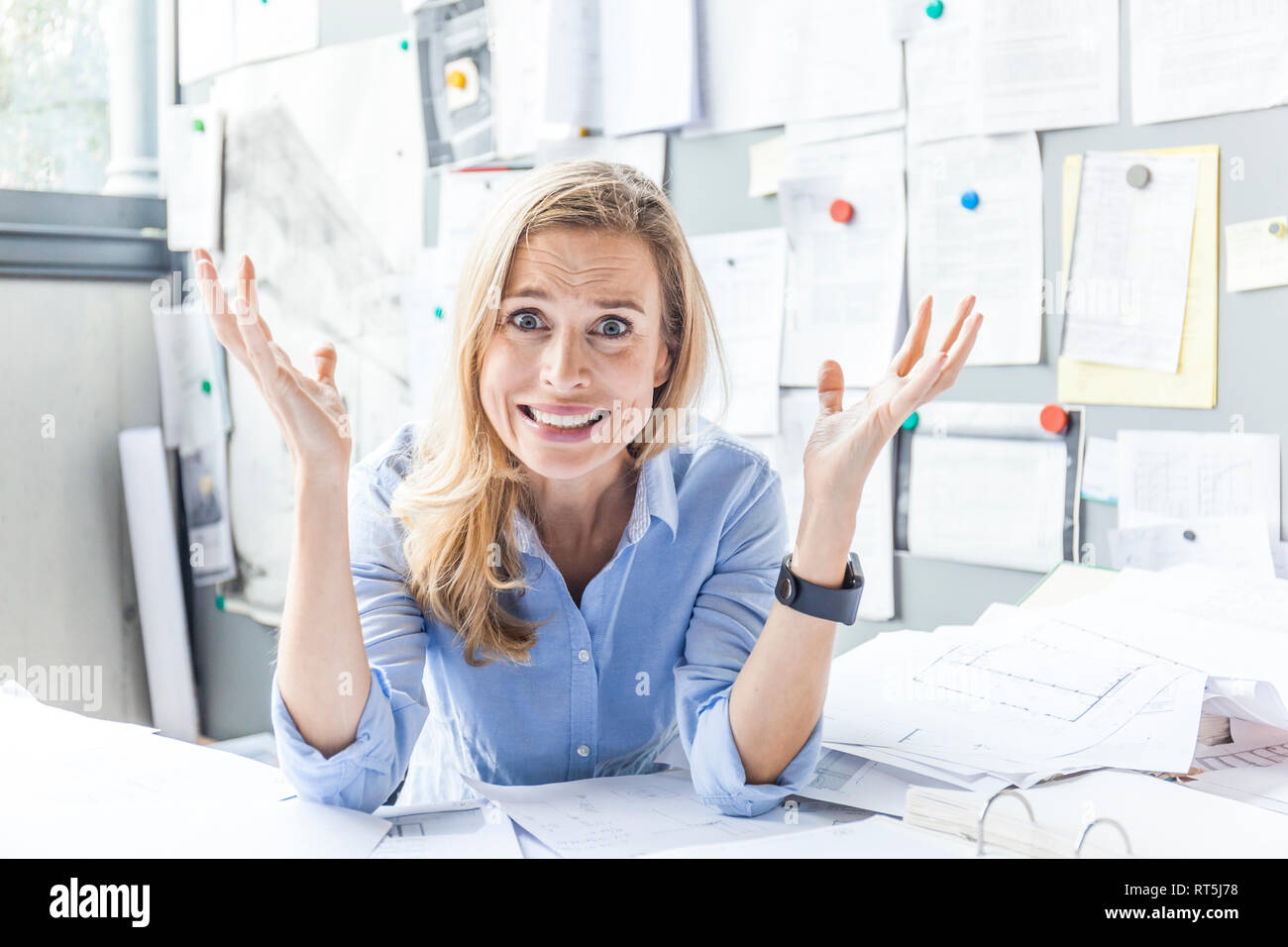 Woman surrounded by paperwork hi-res stock photography and images - Alamy