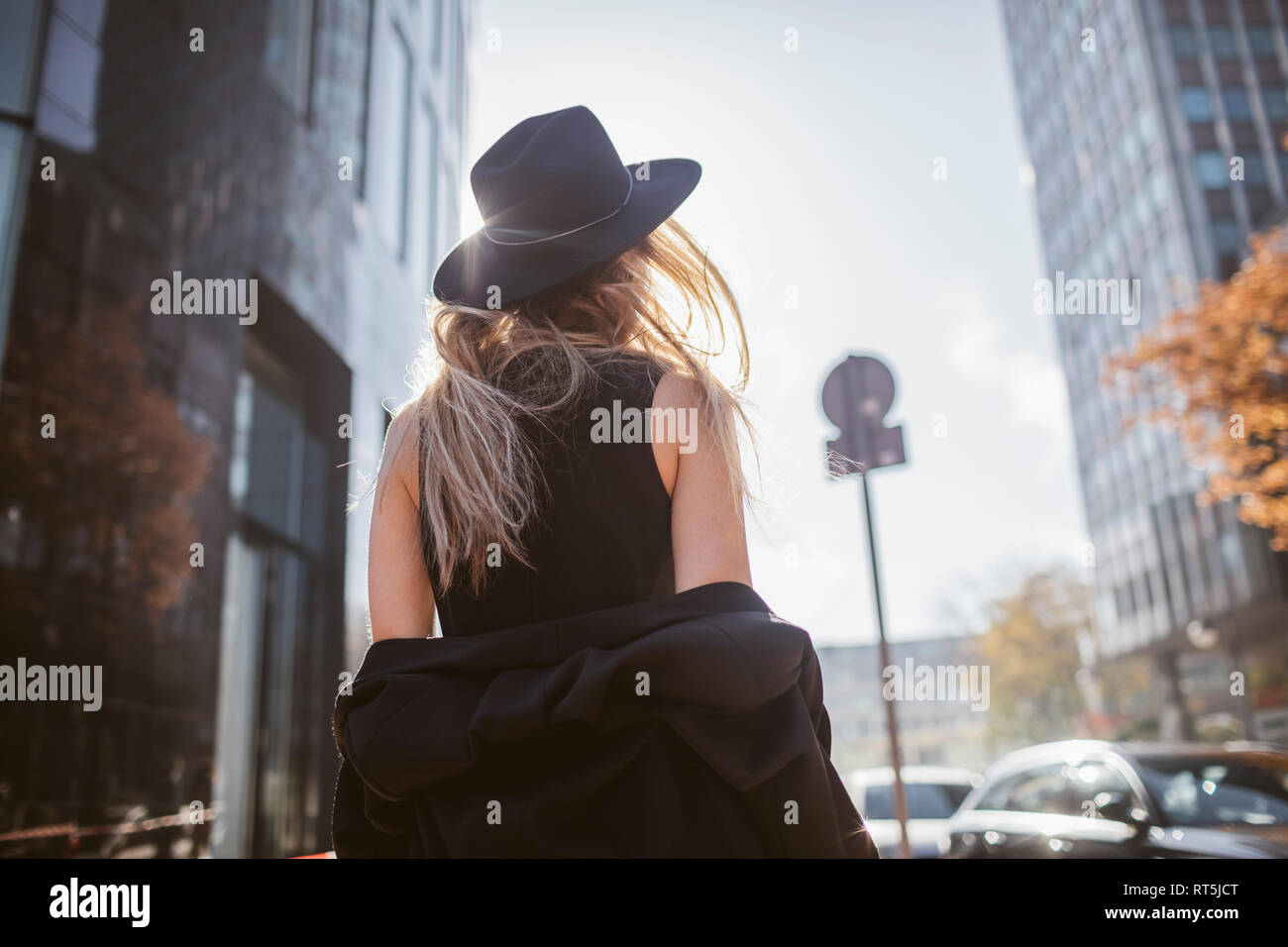 Back view of woman with hat dressed in black Stock Photo - Alamy