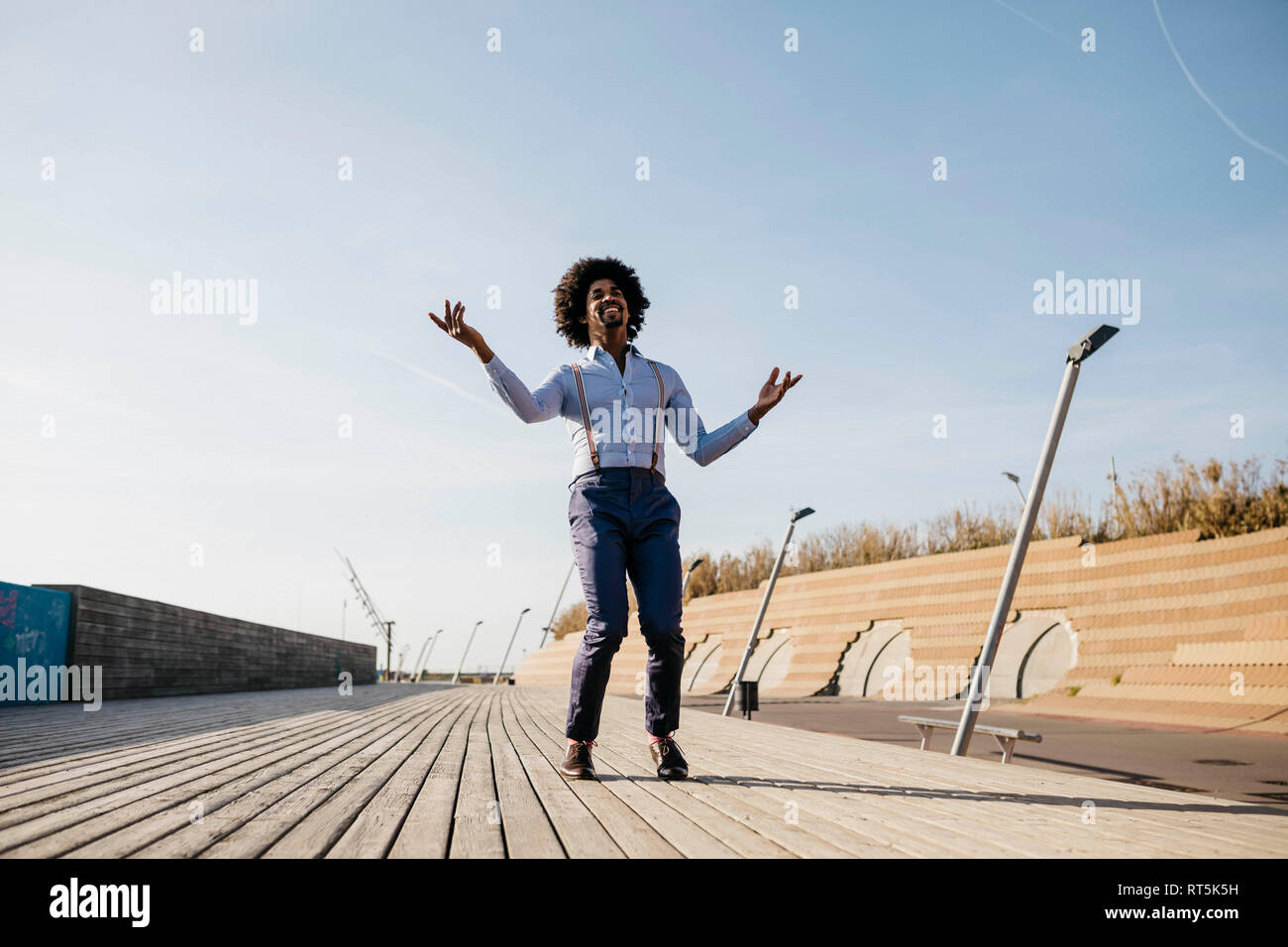 Man dancing on boardwalk Stock Photo - Alamy