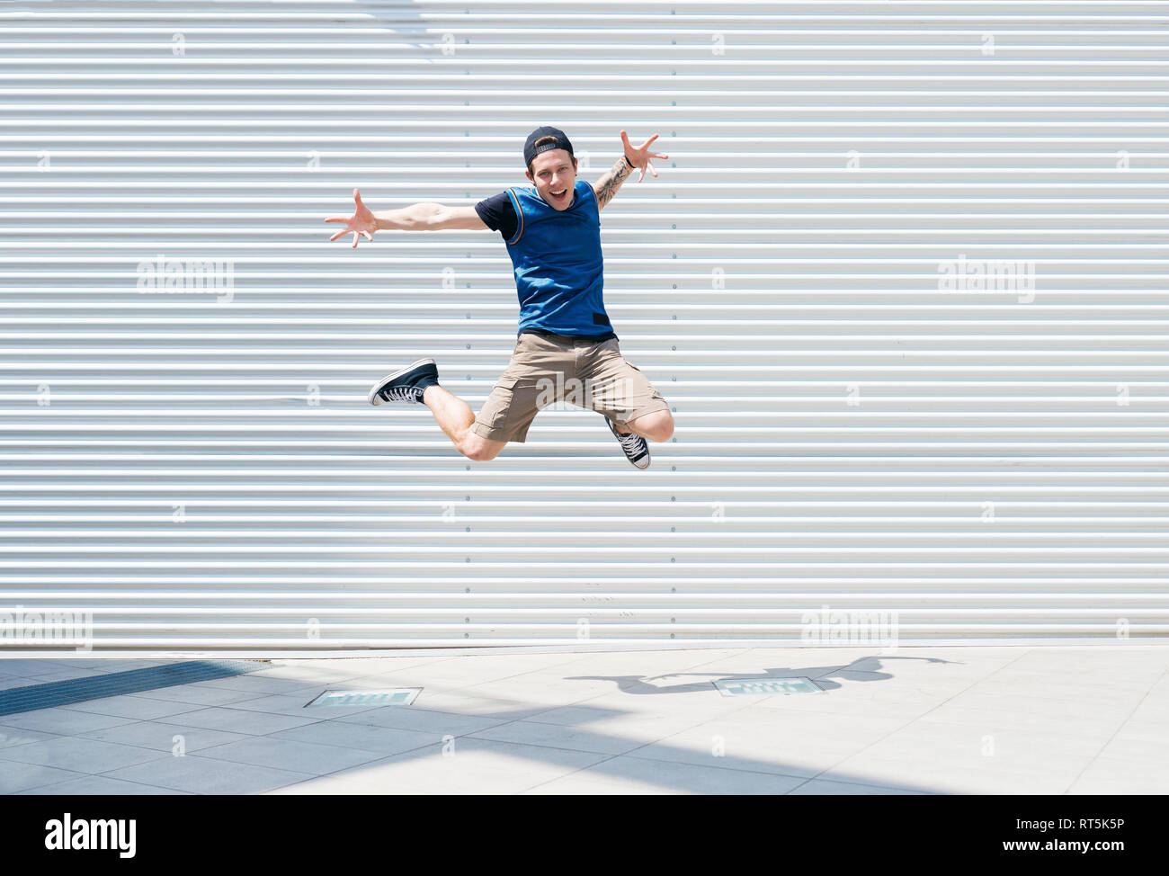 Young man jumping in the air Stock Photo - Alamy