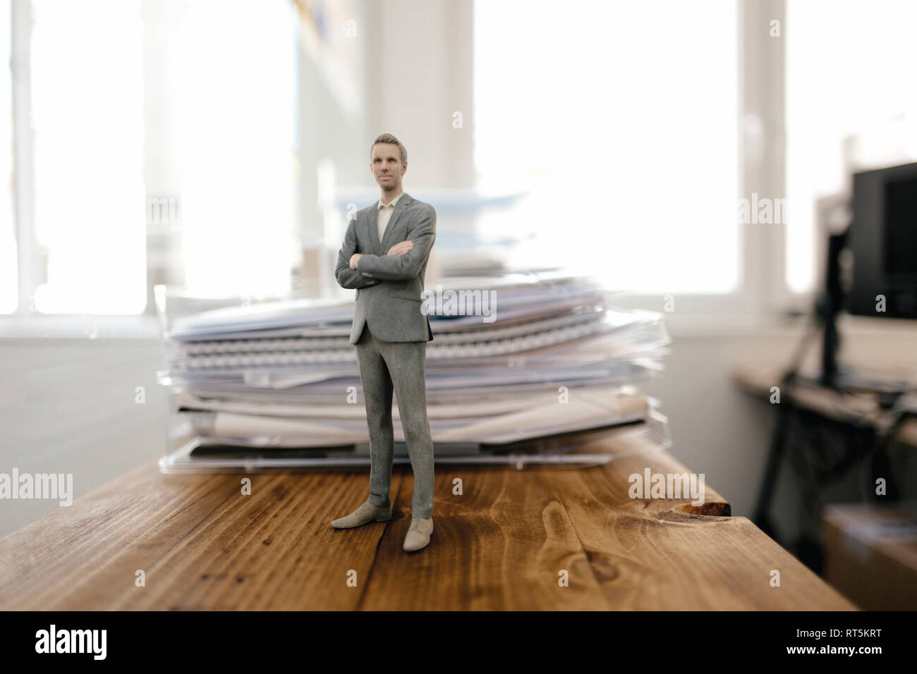 Businessman figurine standing on desk with files Stock Photo - Alamy