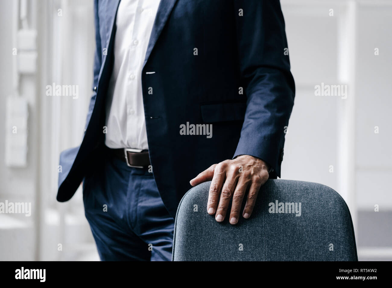 Man standing behind chair hi-res stock photography and images - Alamy