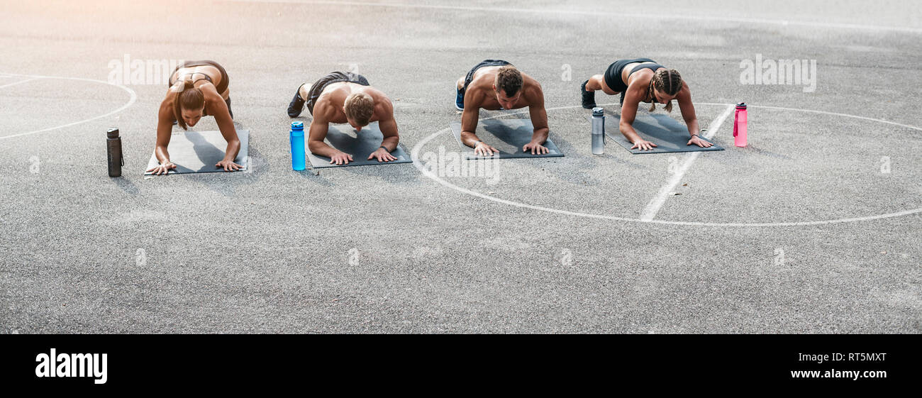 Sporty team during workout, plank Stock Photo - Alamy