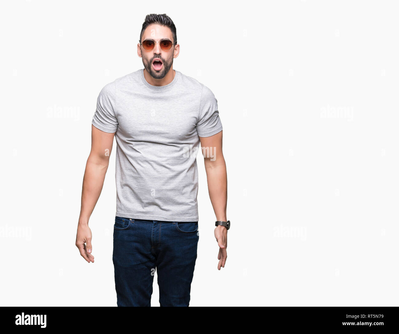 Young handsome man wearing sunglasses over isolated background afraid and shocked with surprise ...