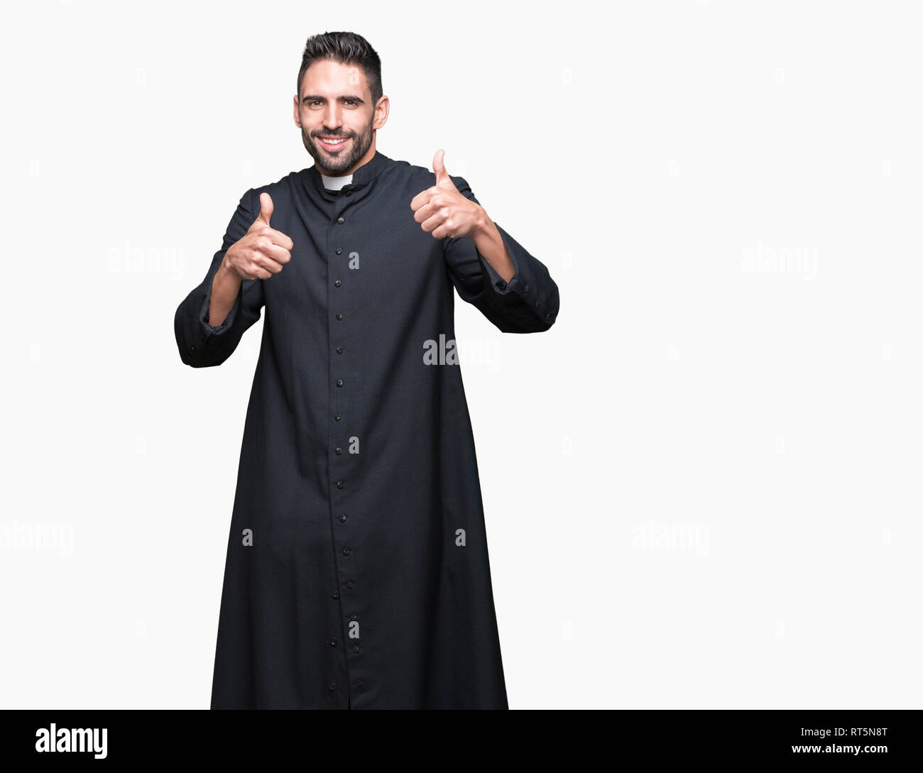 Young Christian priest over isolated background success sign doing ...