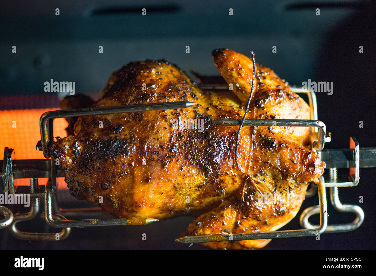Rotisseri chicken on grill Stock Photo - Alamy
