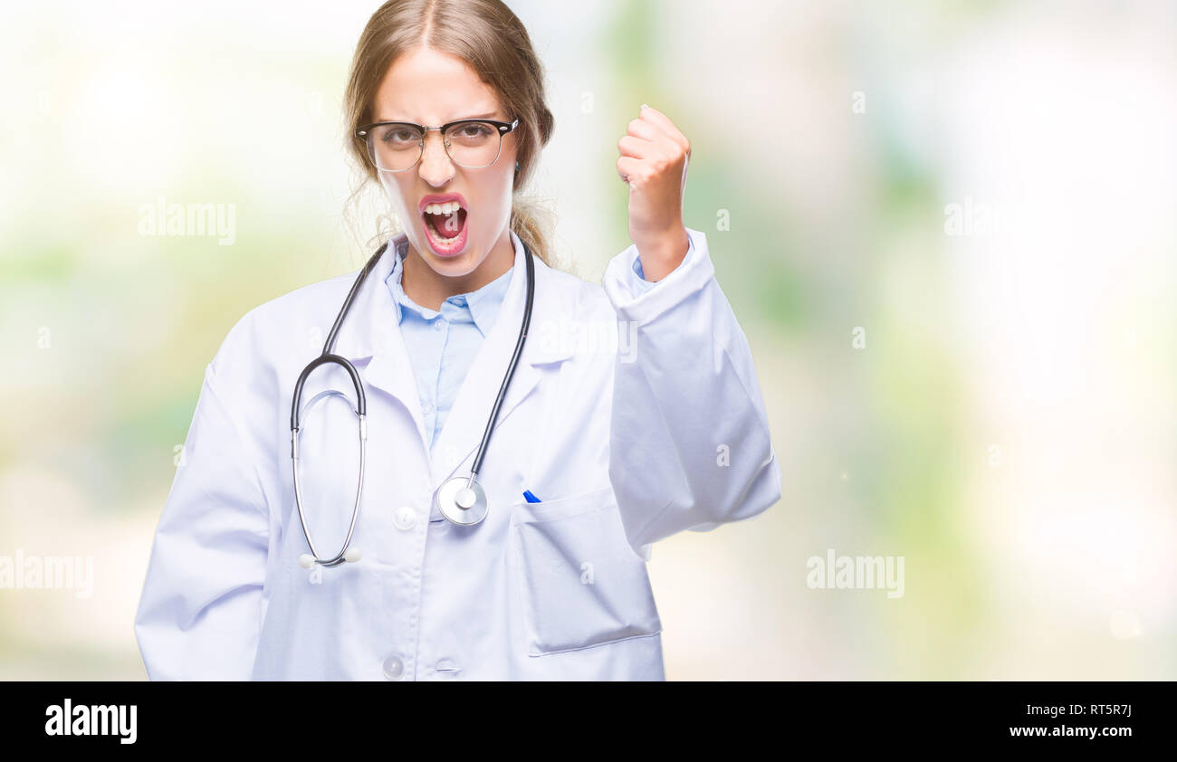 Beautiful young blonde doctor woman wearing medical uniform over ...