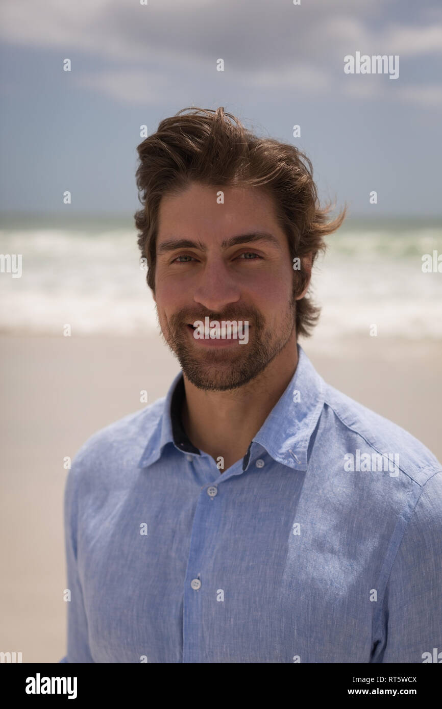 Happy man standing on the beach Stock Photo - Alamy