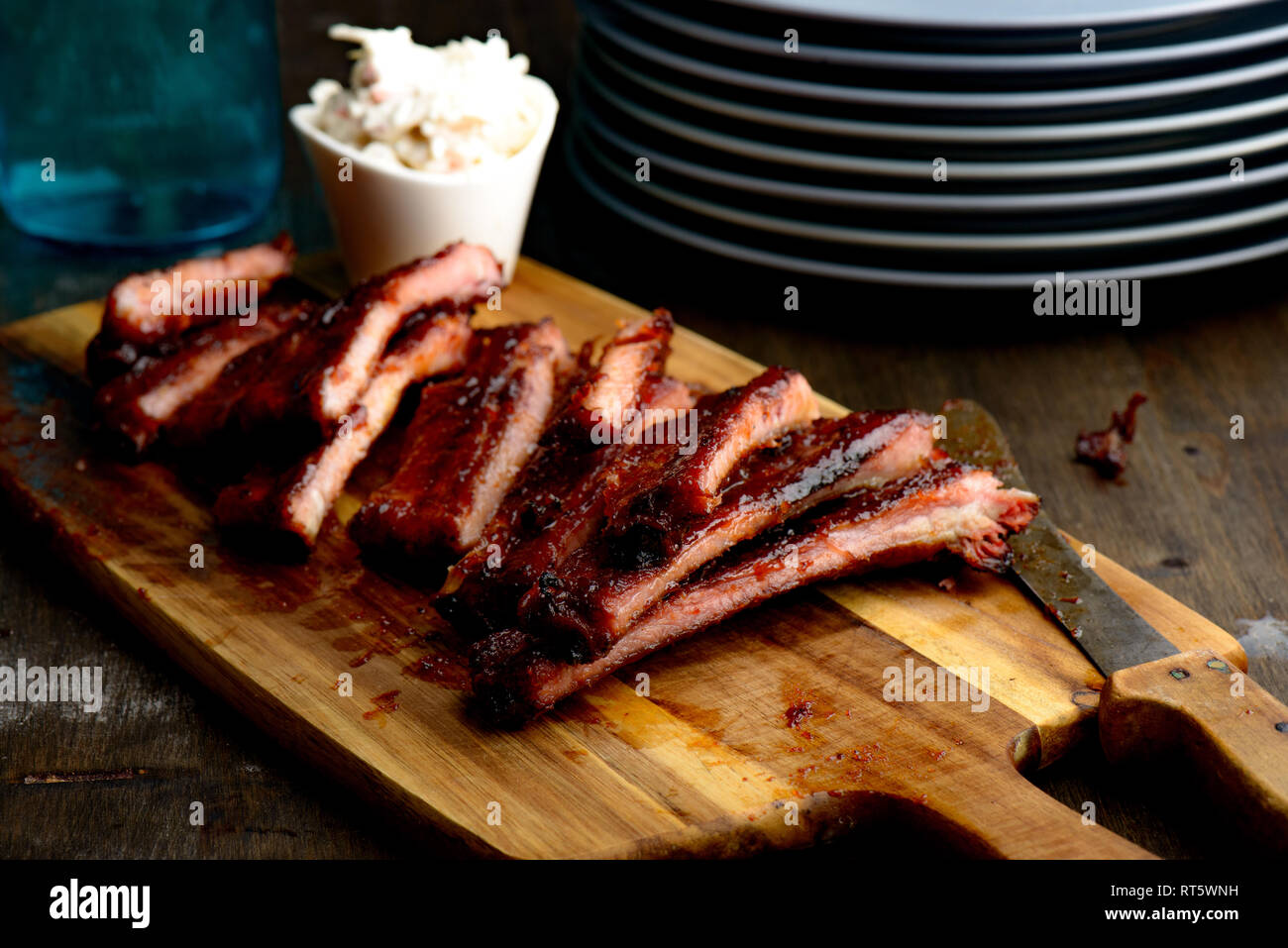 Smoked ribs ready to be eaten on wooden plate Stock Photo - Alamy