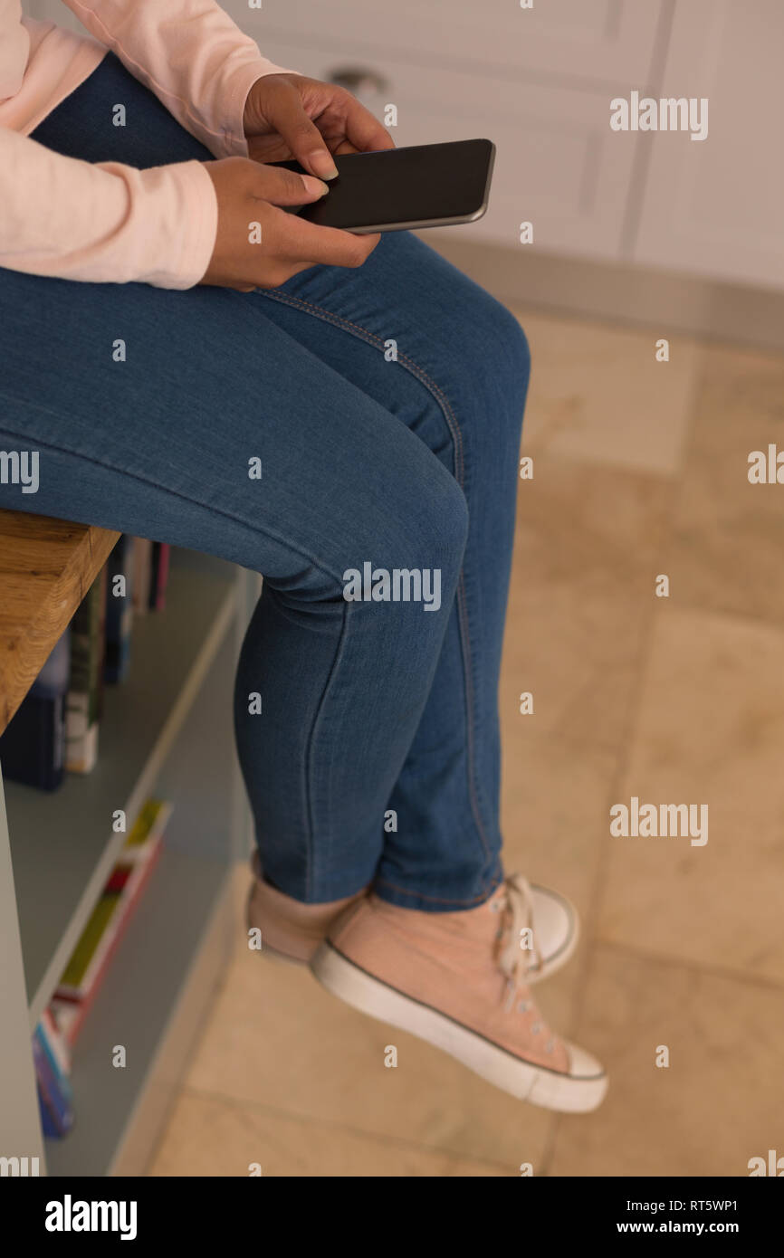 Woman using mobile phone at home Stock Photo - Alamy