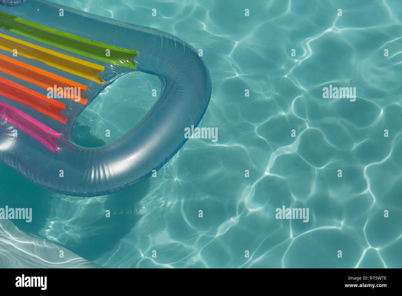 Inflatable tube floating in a swimming pool Stock Photo - Alamy