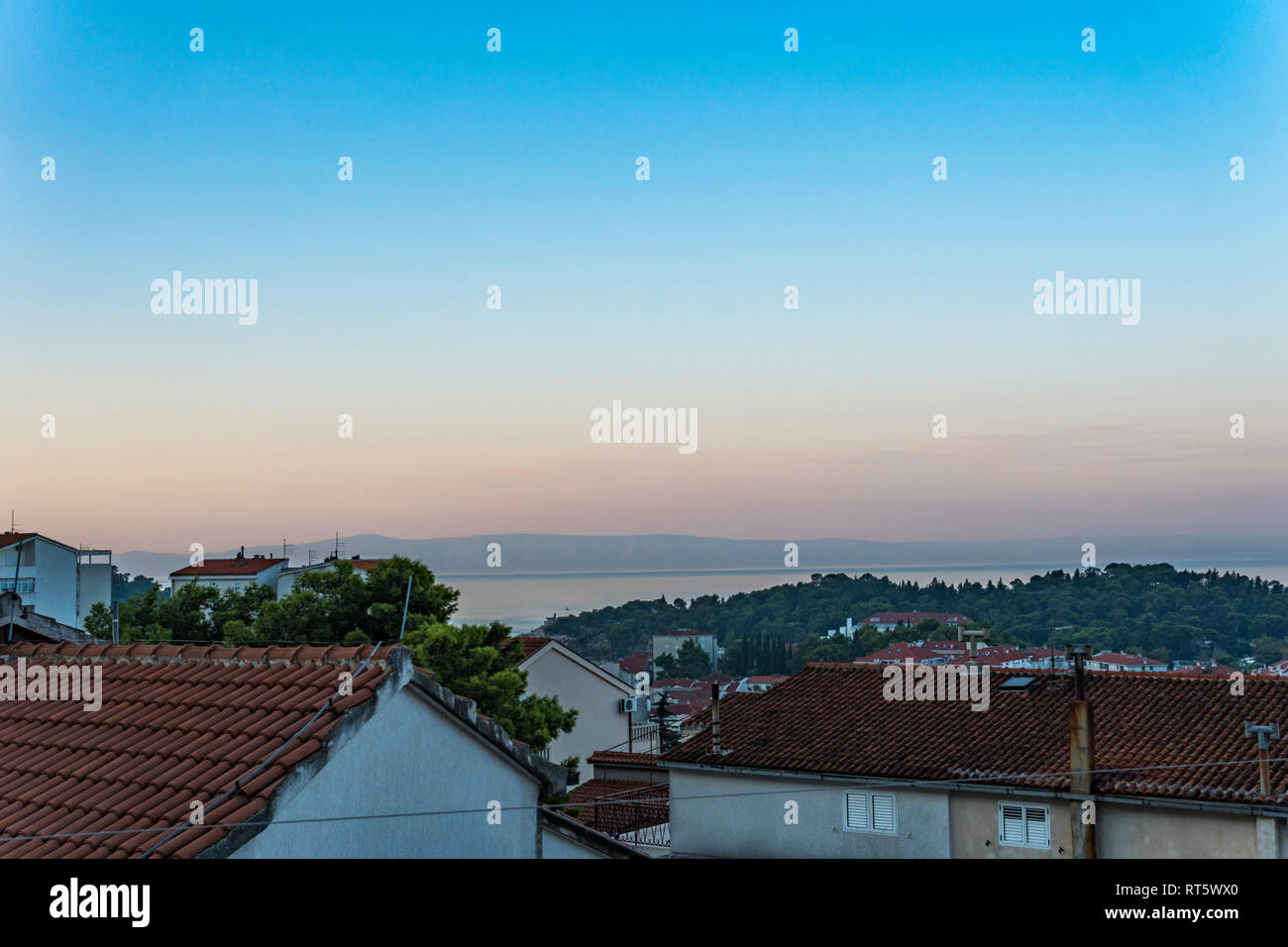scarlet sunset over the sea view from the window Stock Photo - Alamy