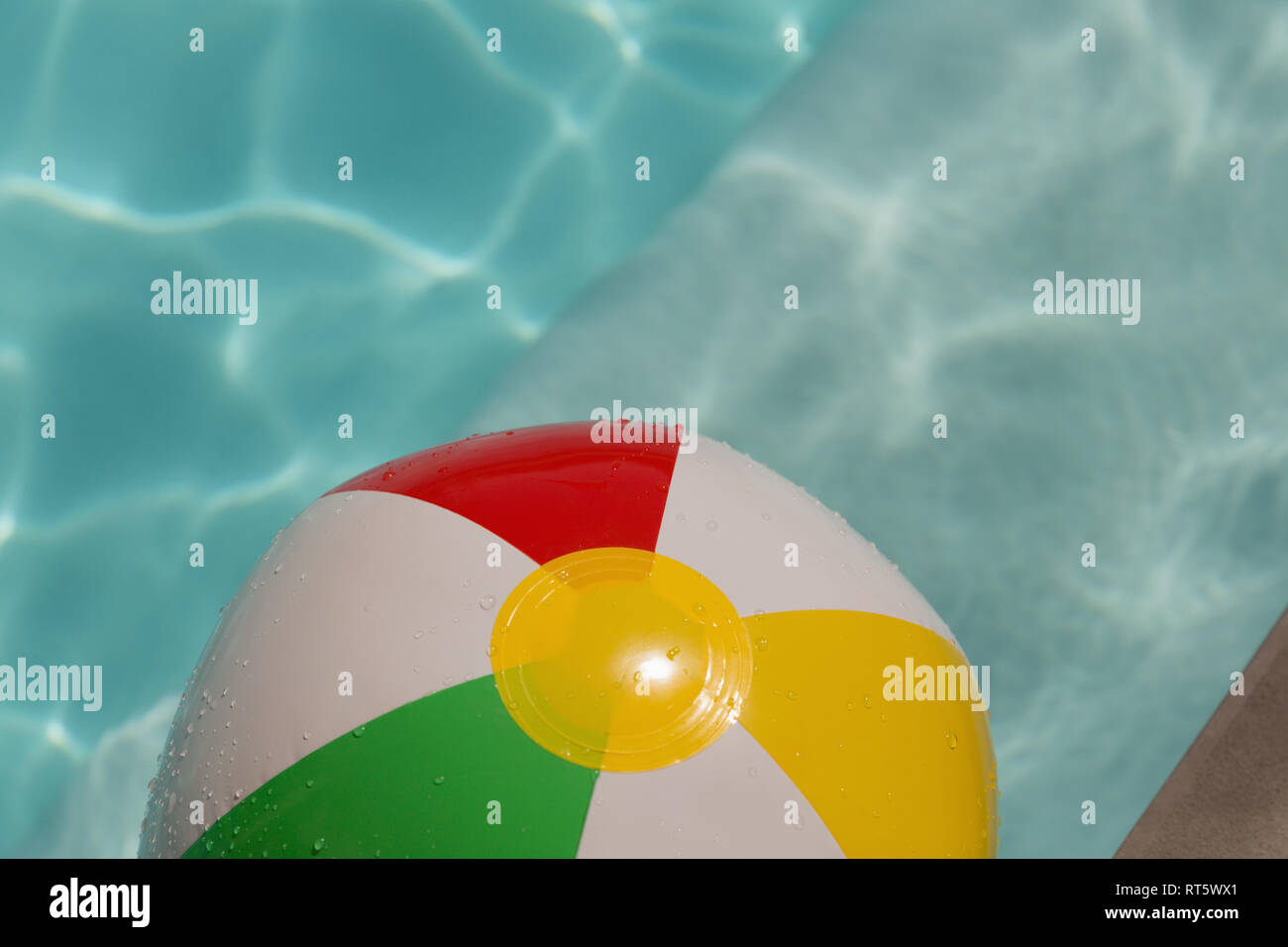 Inflatable ball floating in swimming pool Stock Photo - Alamy
