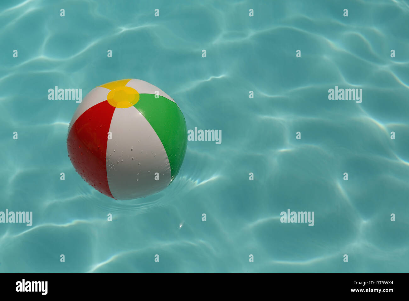 Inflatable ball floating in swimming pool Stock Photo - Alamy