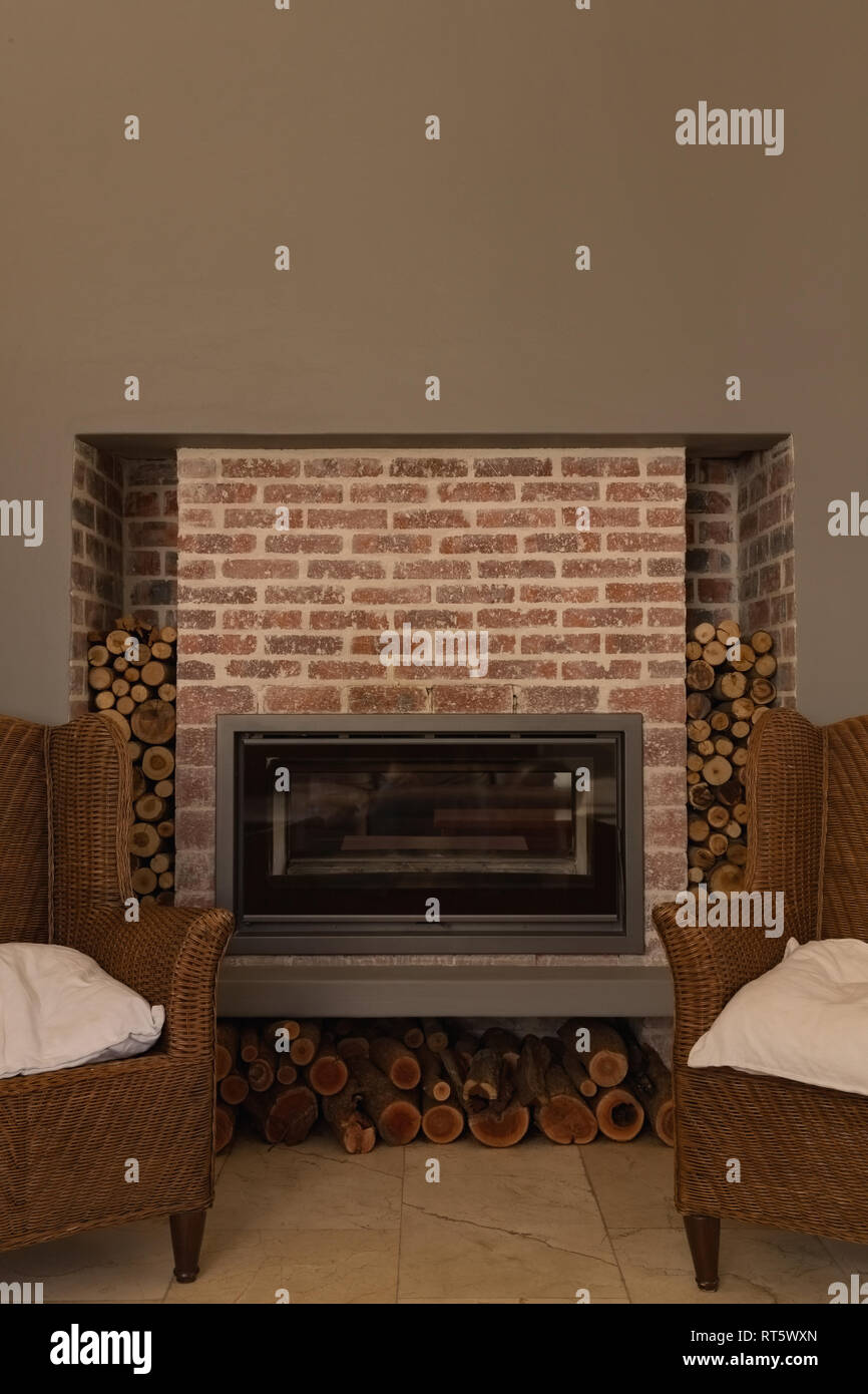 Fireplace in living room at home with chairs Stock Photo - Alamy