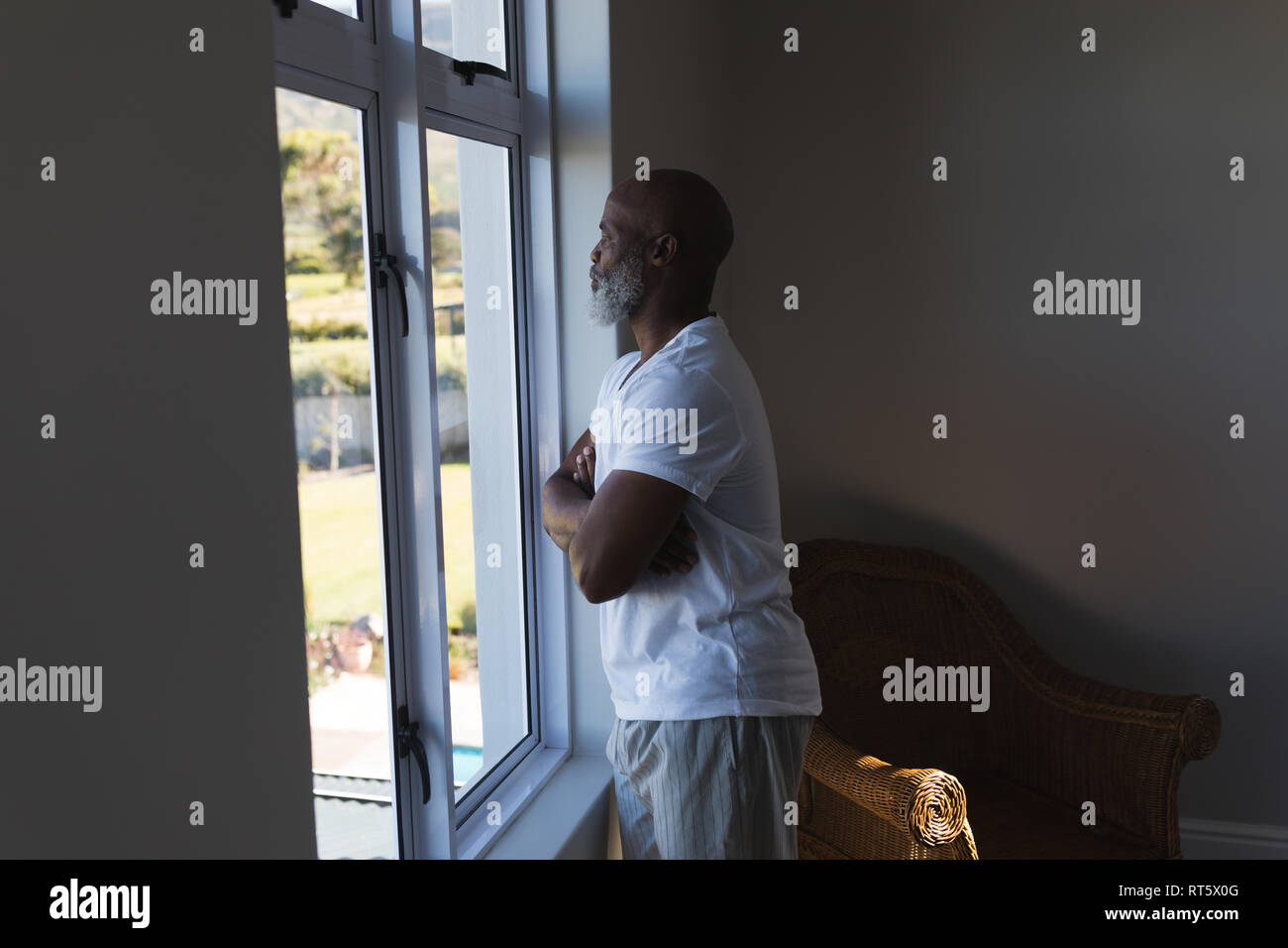 Man looking through window house sad hi-res stock photography and ...