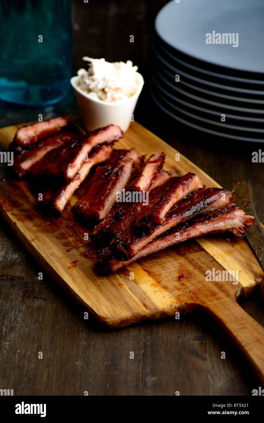 Smoked ribs ready to be eaten on wooden plate Stock Photo - Alamy