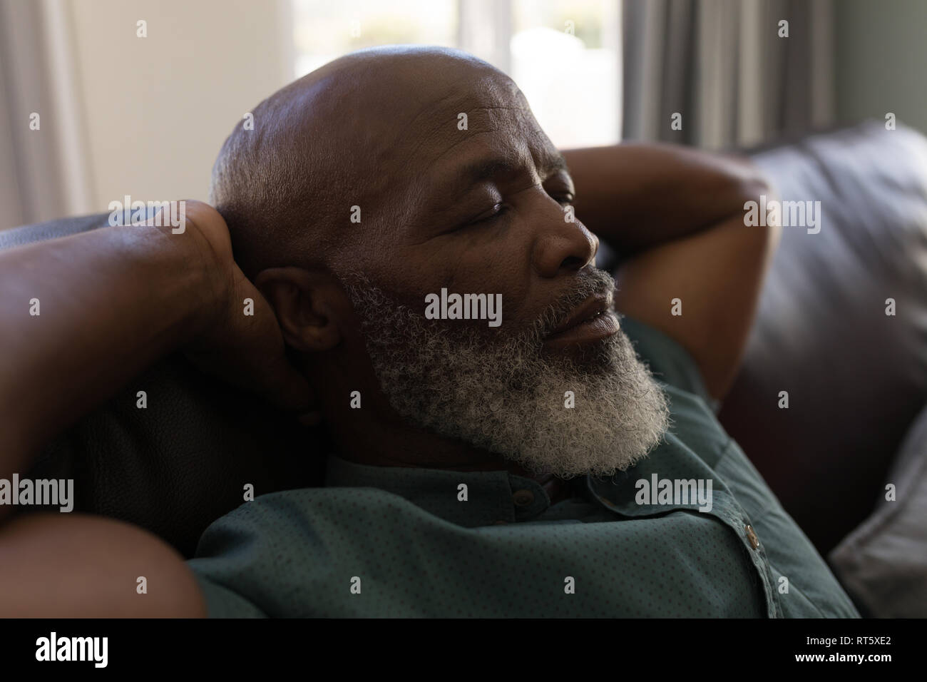 Senior man sleeping in living room Stock Photo - Alamy