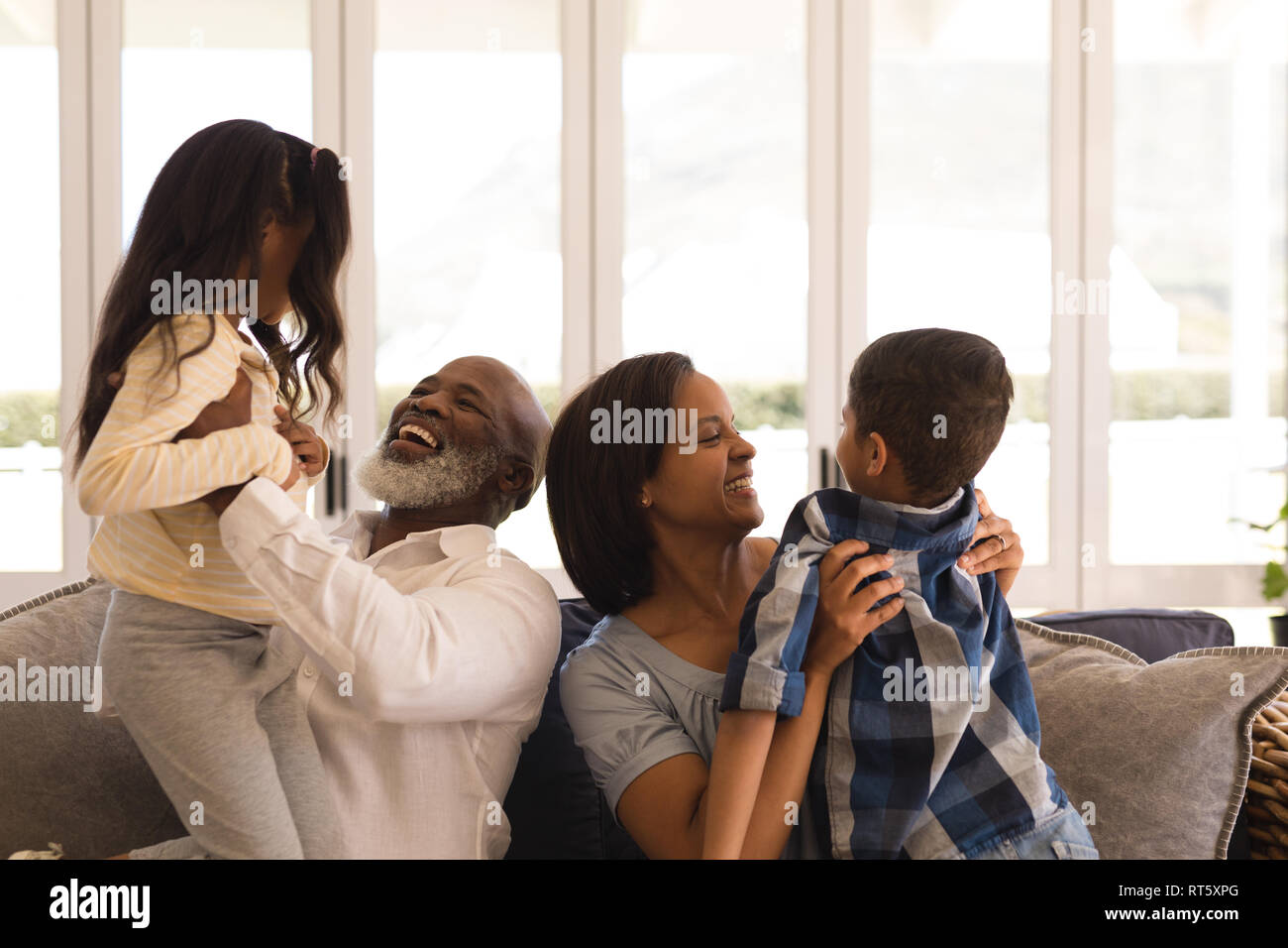 Multi-generation family having fun in living room Stock Photo - Alamy