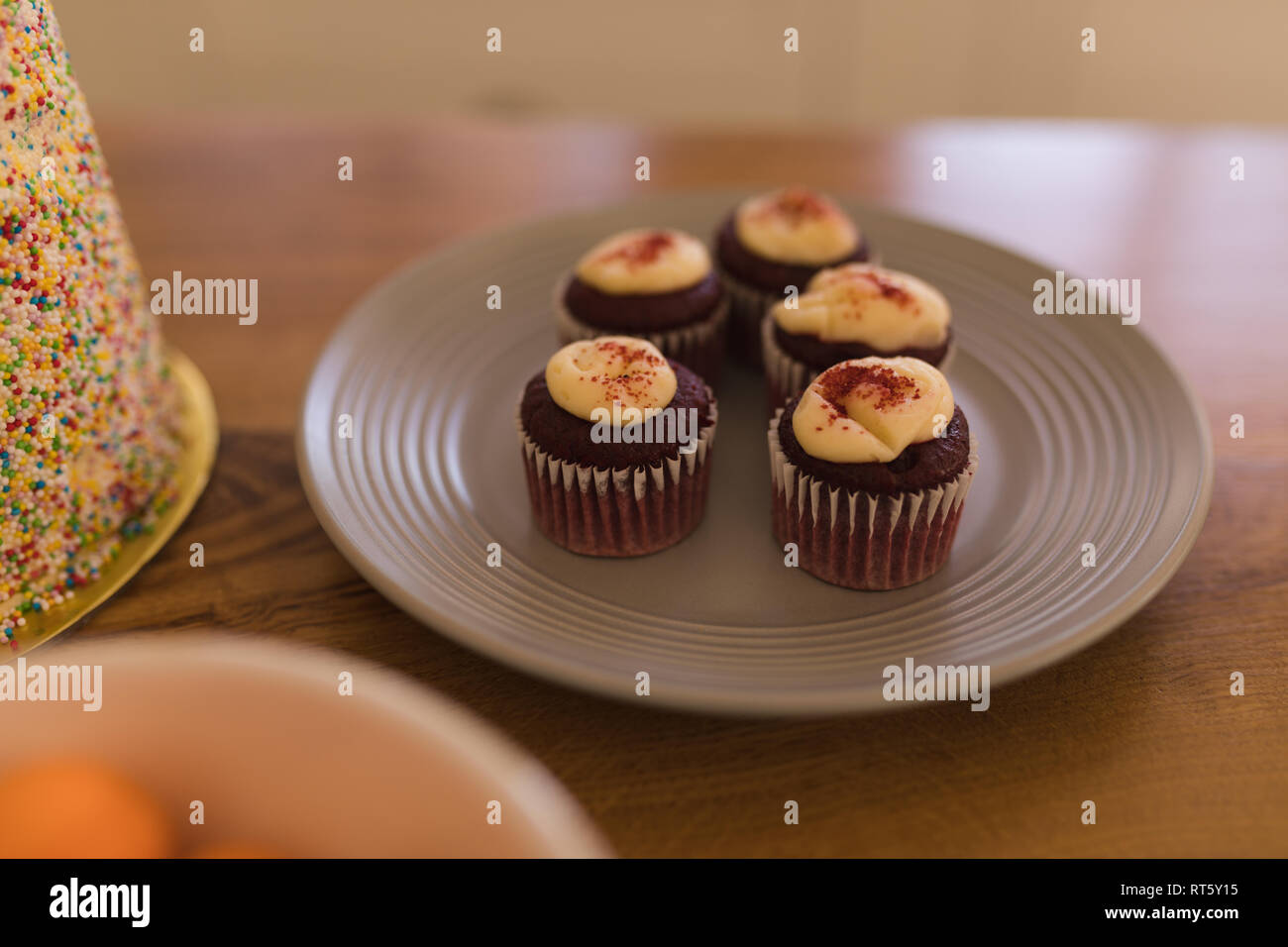 Cupcakes in a plate on a table at home Stock Photo - Alamy