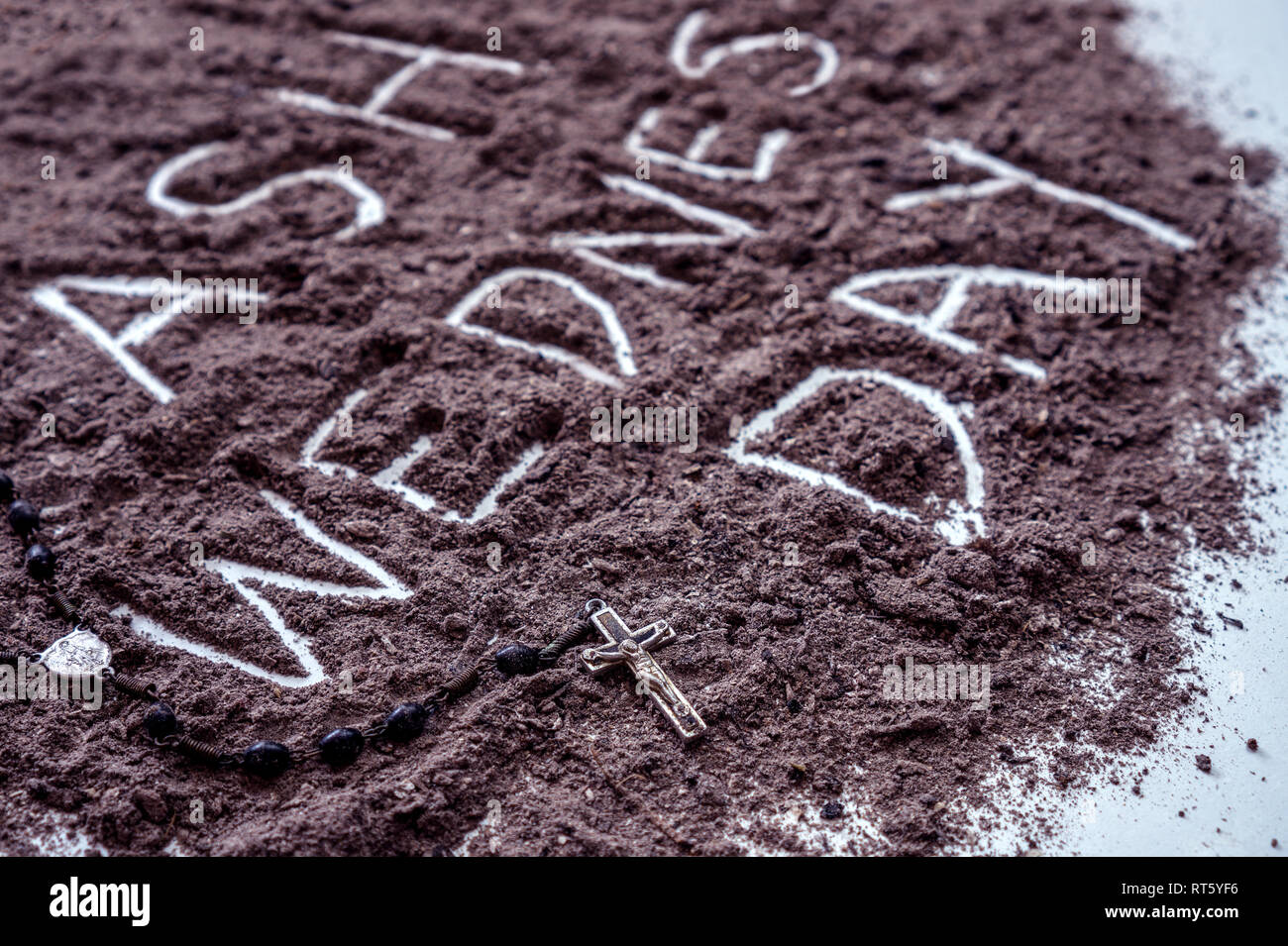 Ash wednesday word written in ash and christian cross on chaplet symbol ...